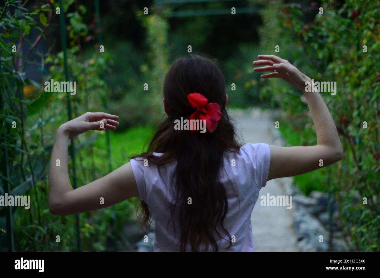 Girl dancing in the garden Stock Photo - Alamy