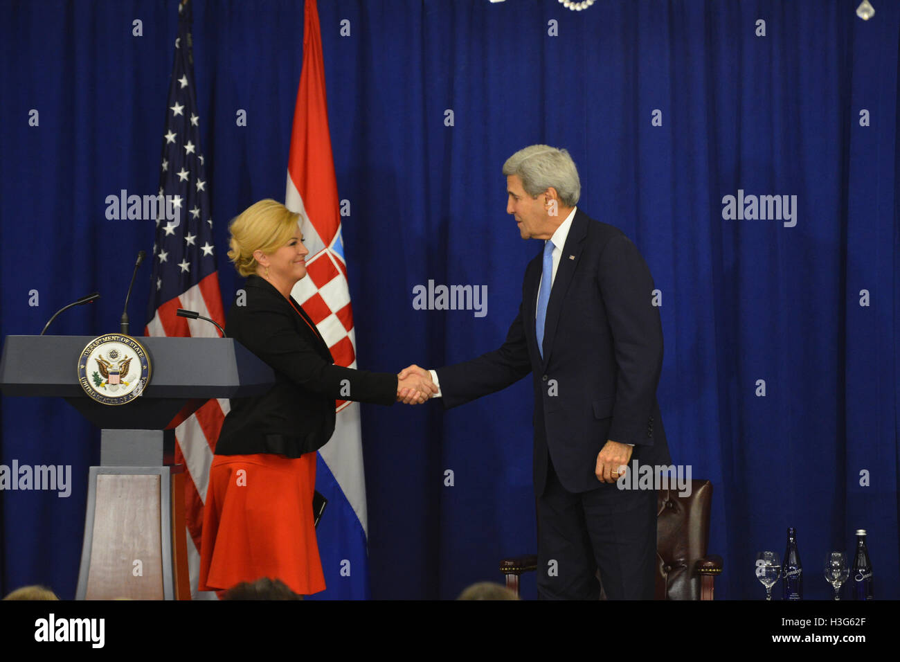 U.S. Secretary of State John Kerry shakes hands with President of the ...