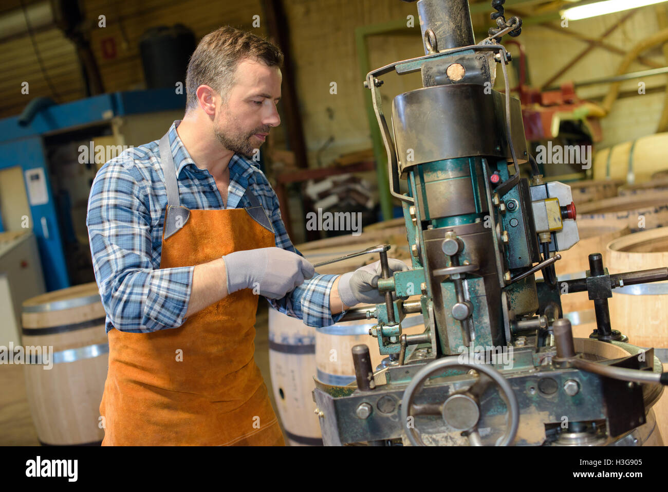 Cooper using machinery Stock Photo - Alamy