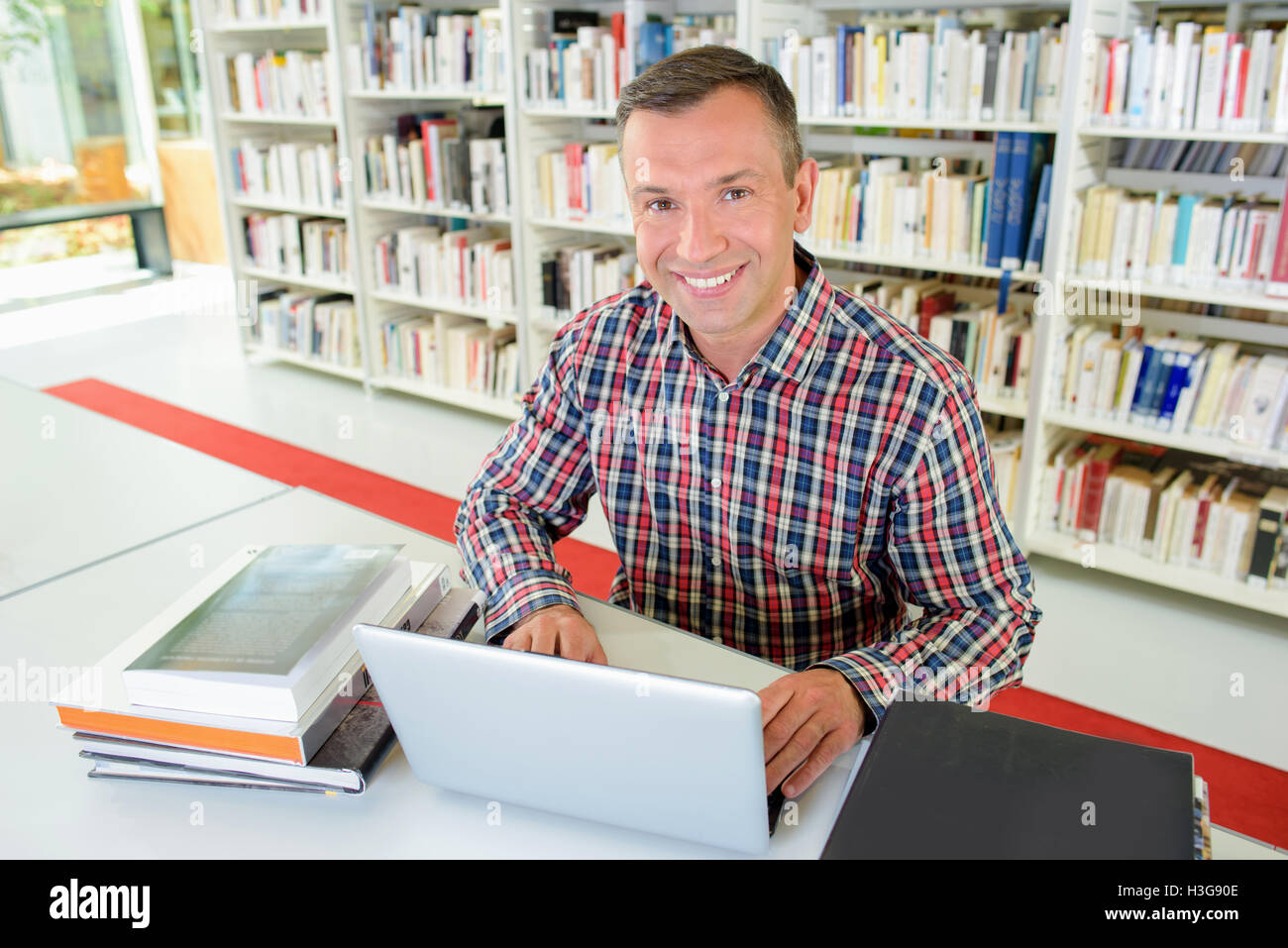 with laptop and books Stock Photo - Alamy