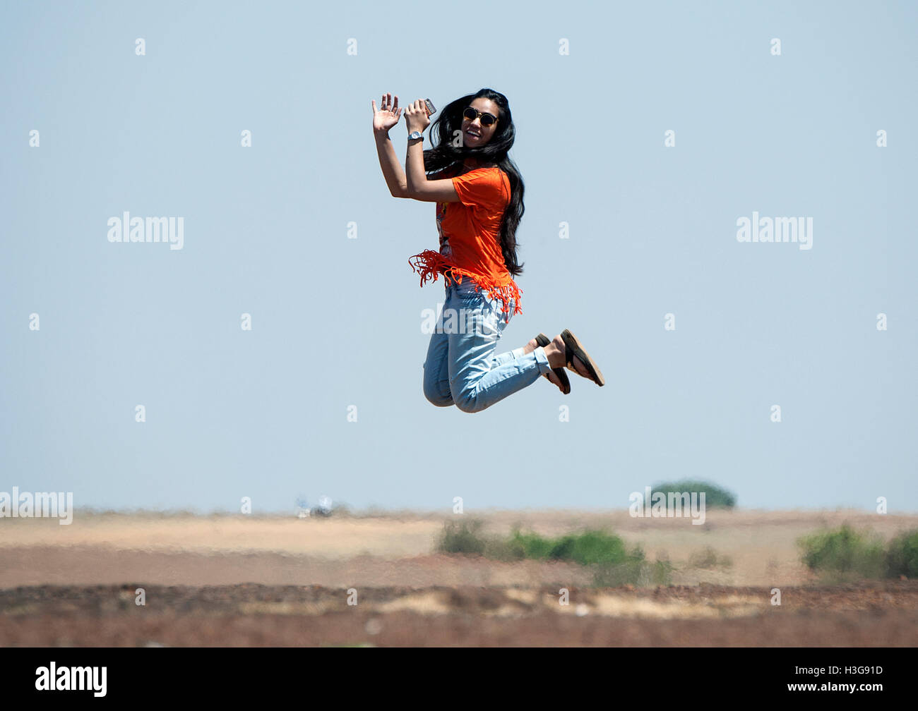 The image of Indian teenage girl lady jumping up in the air, India ...