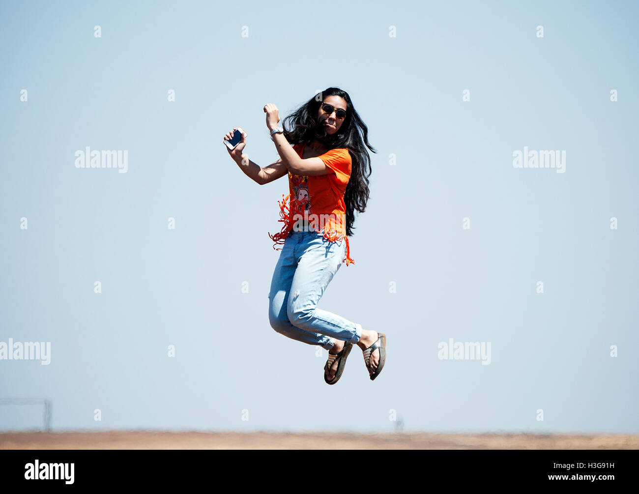 The image of teenage Indian girl jumping up in the air, India Stock ...