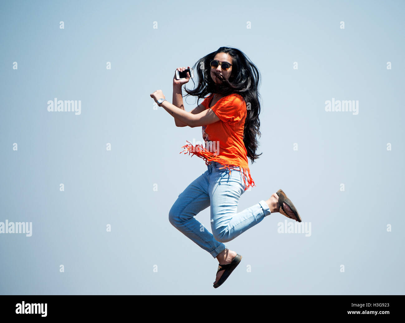 The image of teenage Indian girl jumping up in the air, India Stock ...