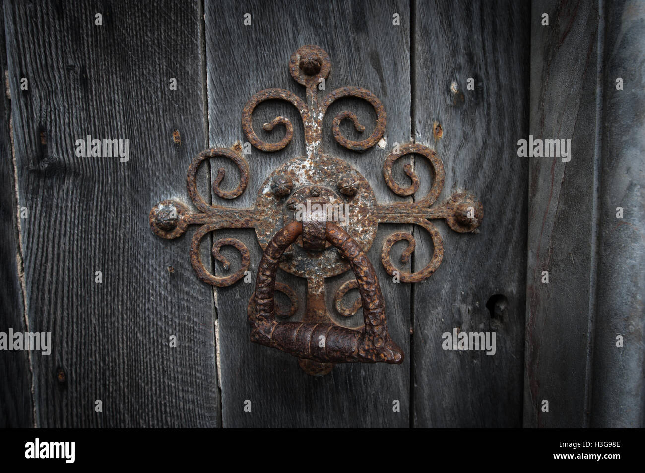 An ornate rusty door handle on a wooden door at Salisbury Cathedral ...