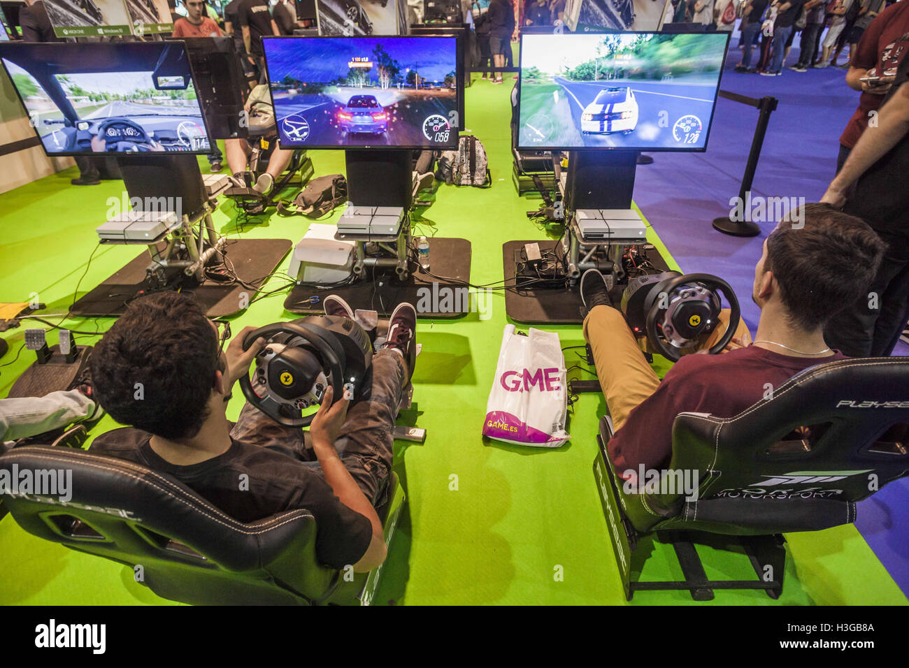Barcelona, Spain. 7th October, 2016. Gamers drive in a computer game ...