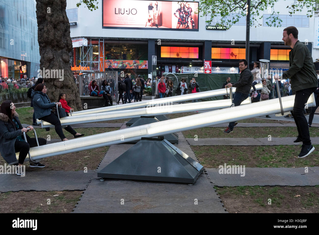 London, UK. Members of the public enjoy riding on the illuminated see ...