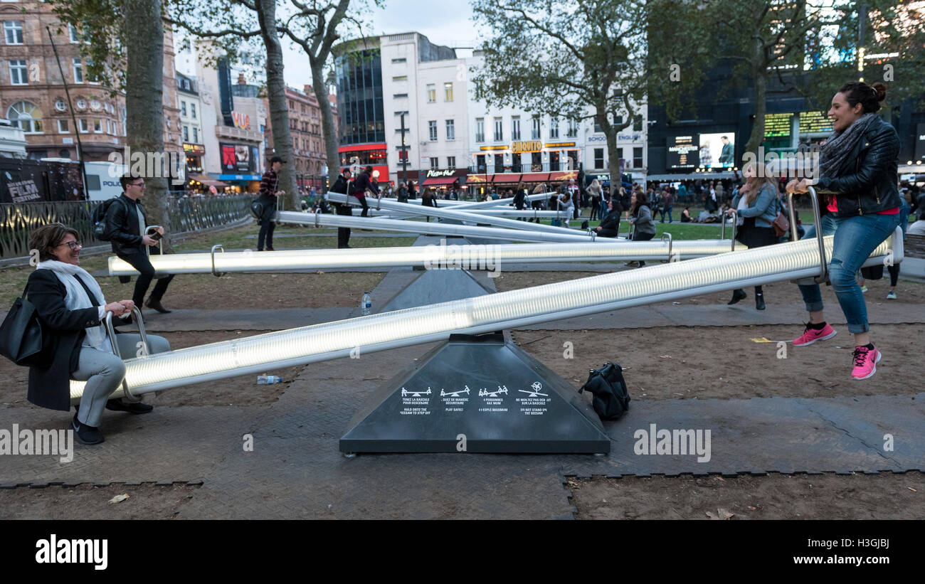 London, UK. Members of the public enjoy riding on the illuminated see ...