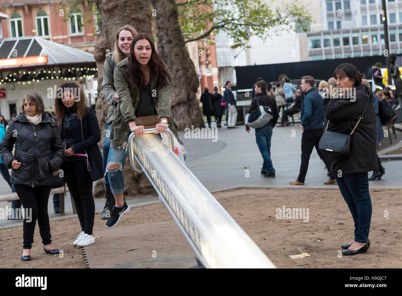 London, UK. Members of the public enjoy riding on the illuminated see ...