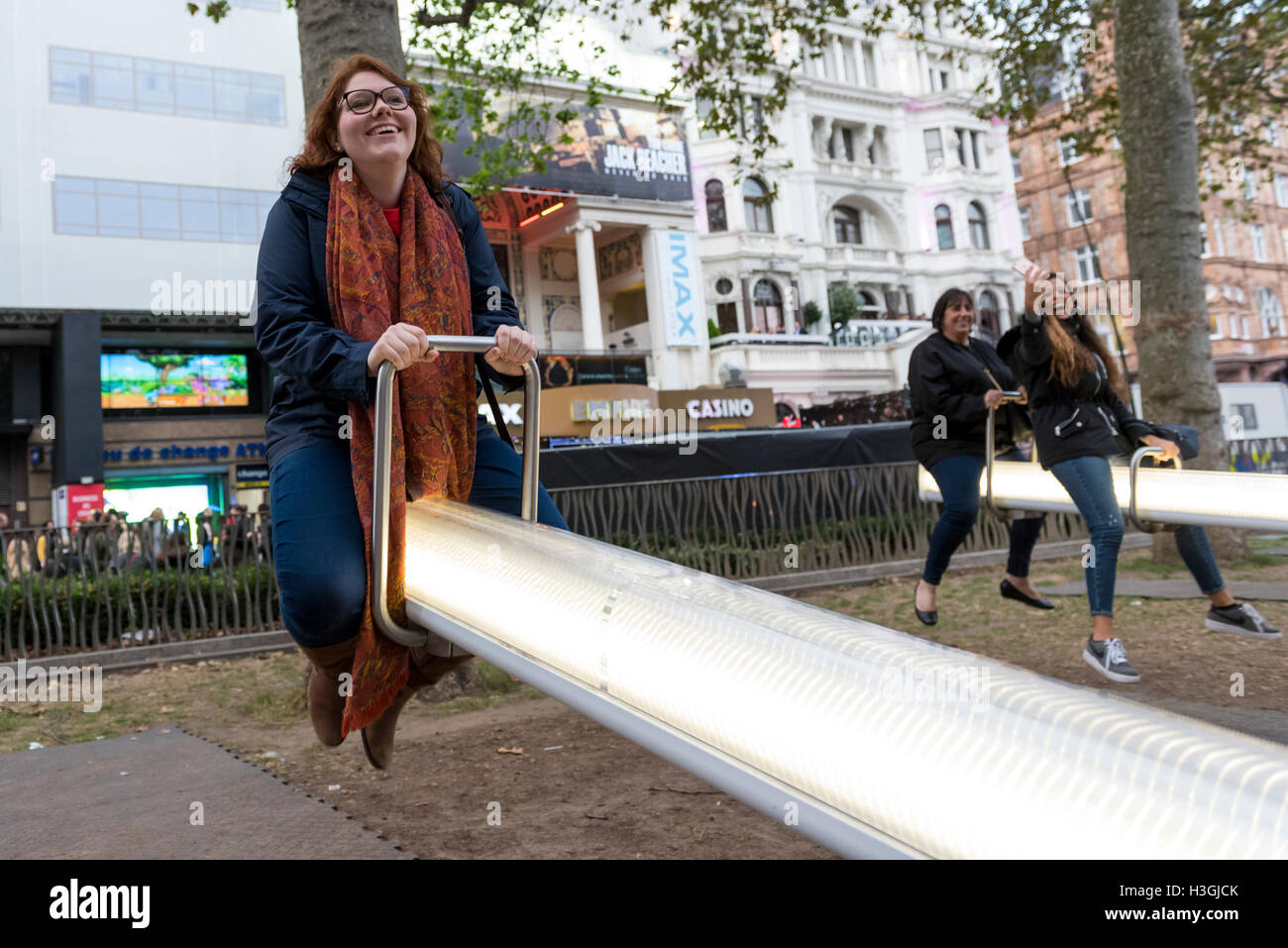 London, UK. Members of the public enjoy riding on the illuminated see ...