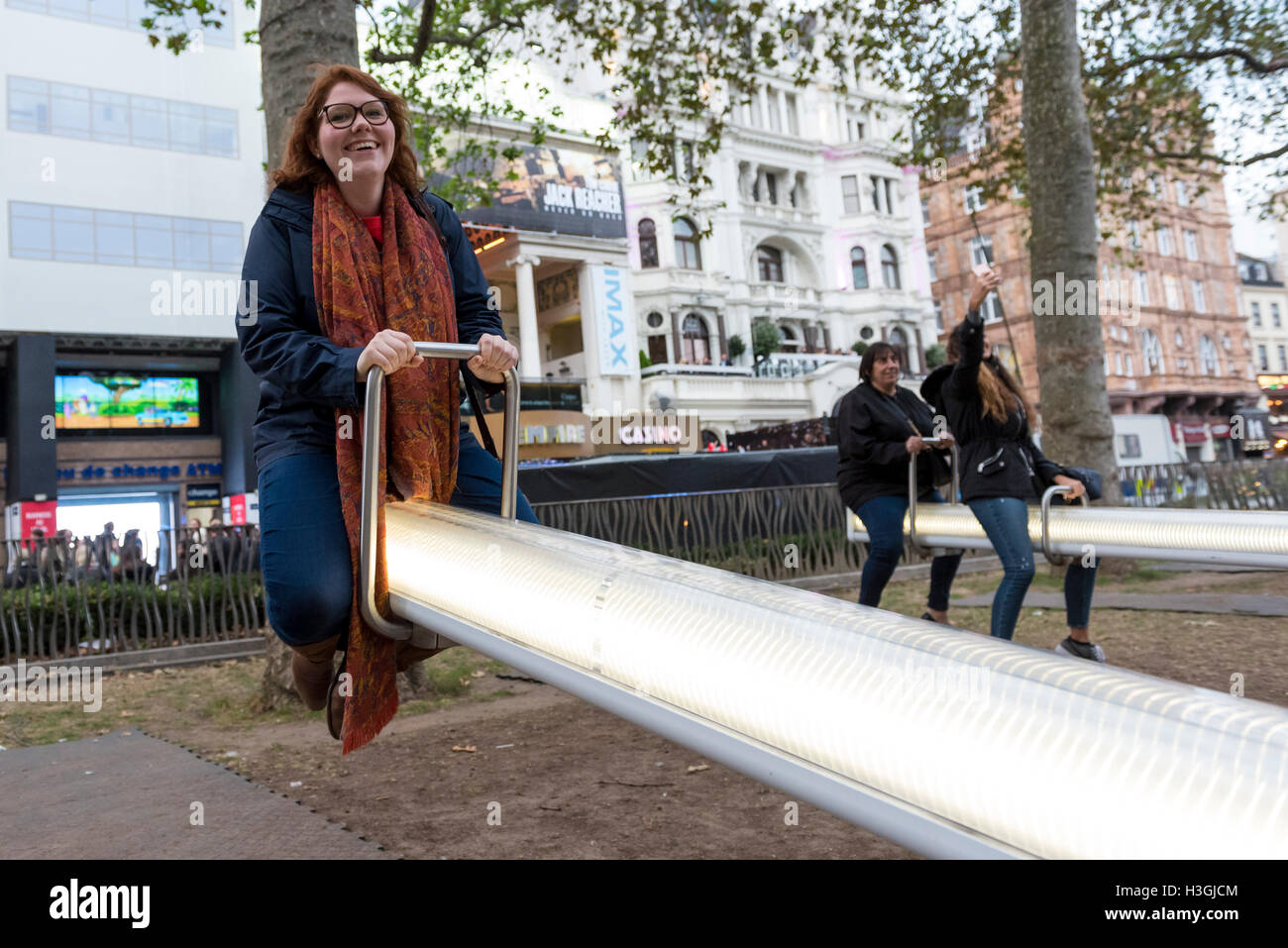 London, UK. Members of the public enjoy riding on the illuminated see ...