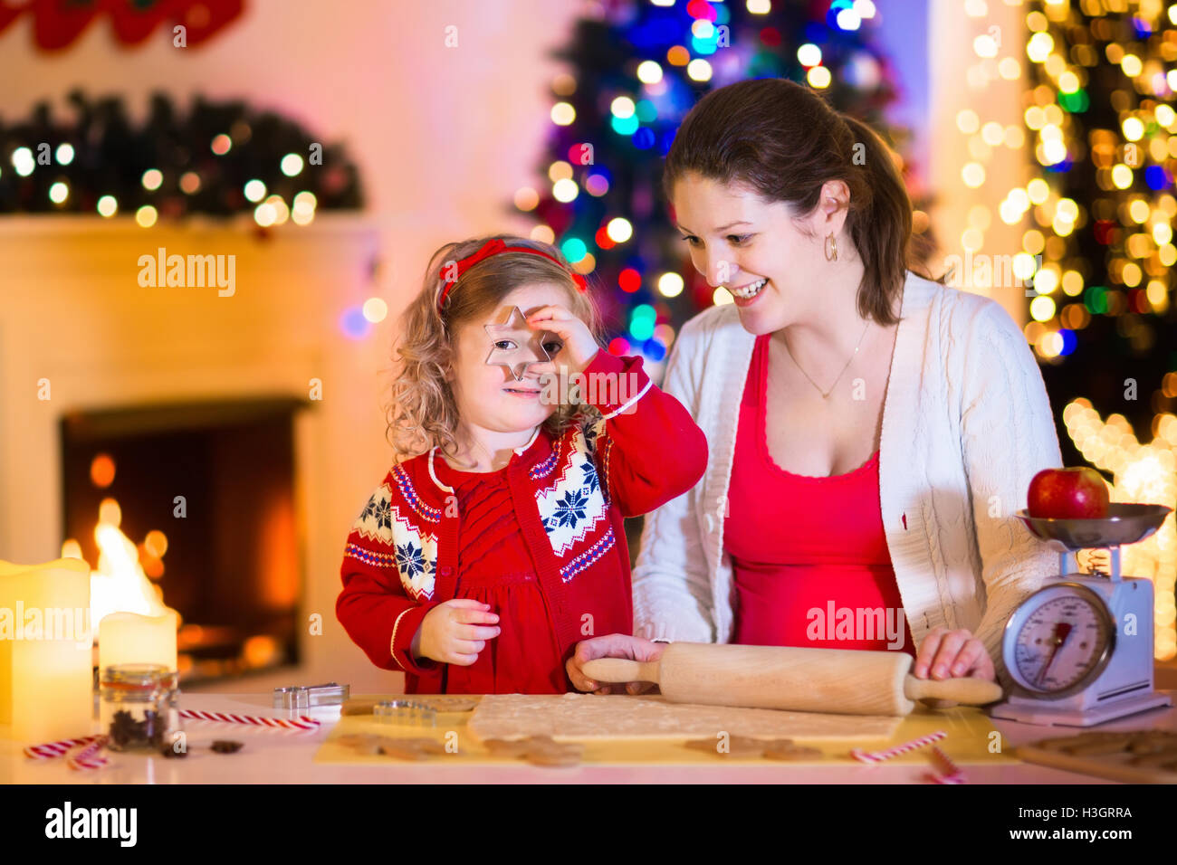 Mother and little girl baking Christmas pastry. Children bake ...
