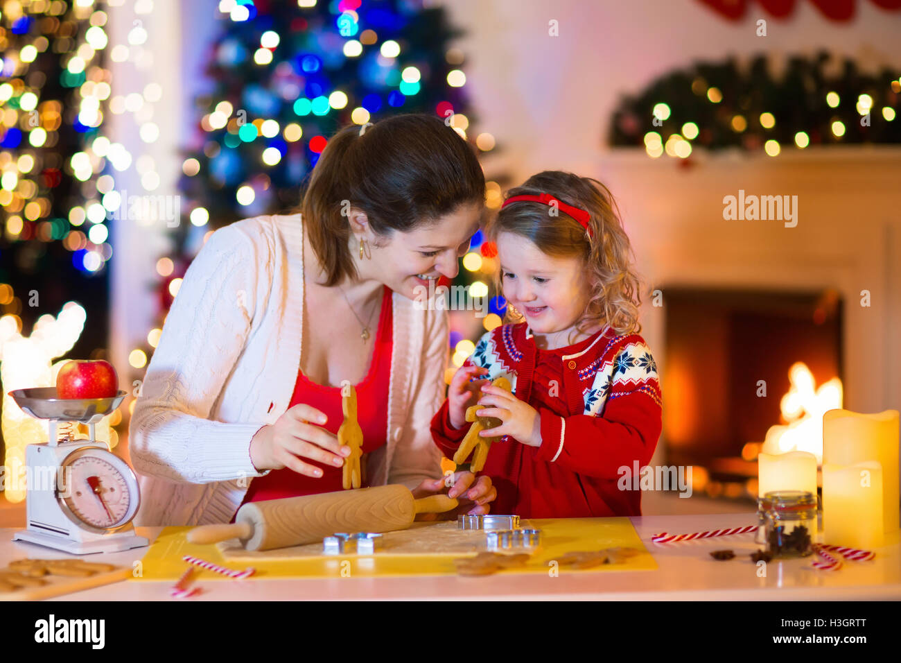 Mother and little girl baking Christmas pastry. Children bake ...