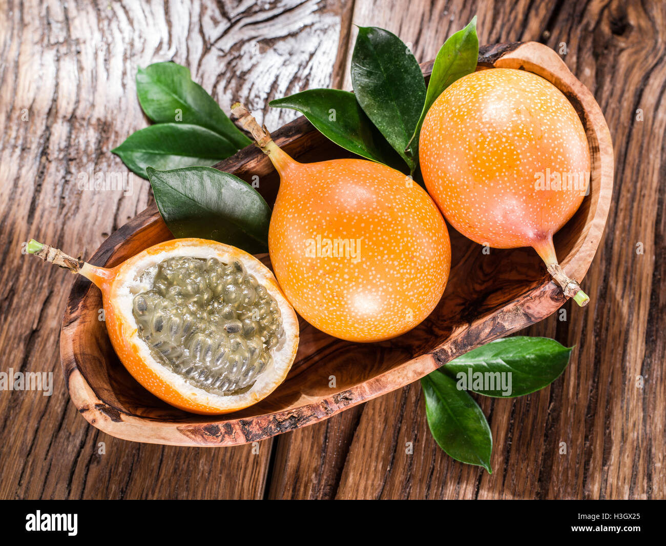 Granadilla fruits on the wooden table Stock Photo - Alamy