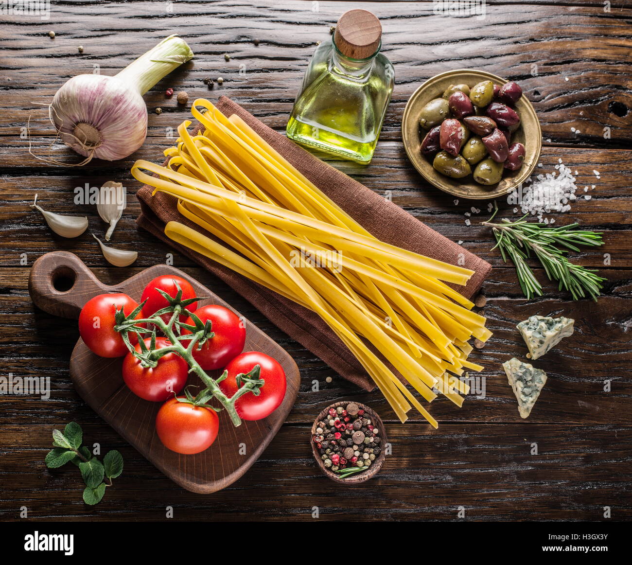 Pasta ingredients. Cherry-tomatoes, spaghetti pasta, rosemary and ...