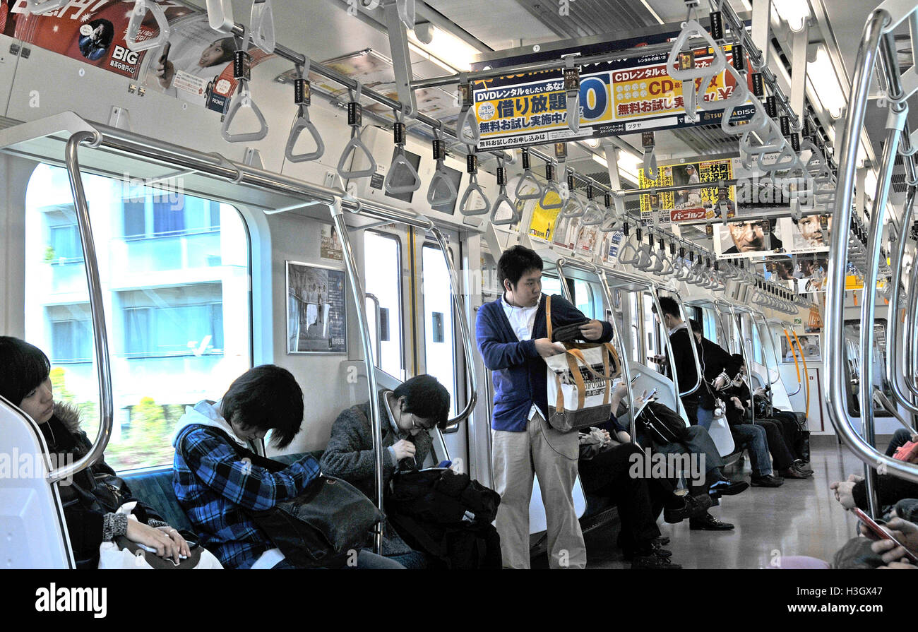 travelers in commuter train Tokyo Japan Stock Photo - Alamy