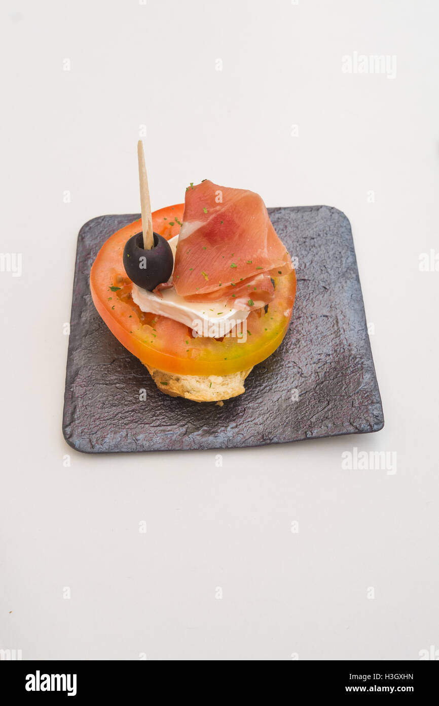 Traditional Spanish tapa, bread with garnish and toothpick Stock Photo ...