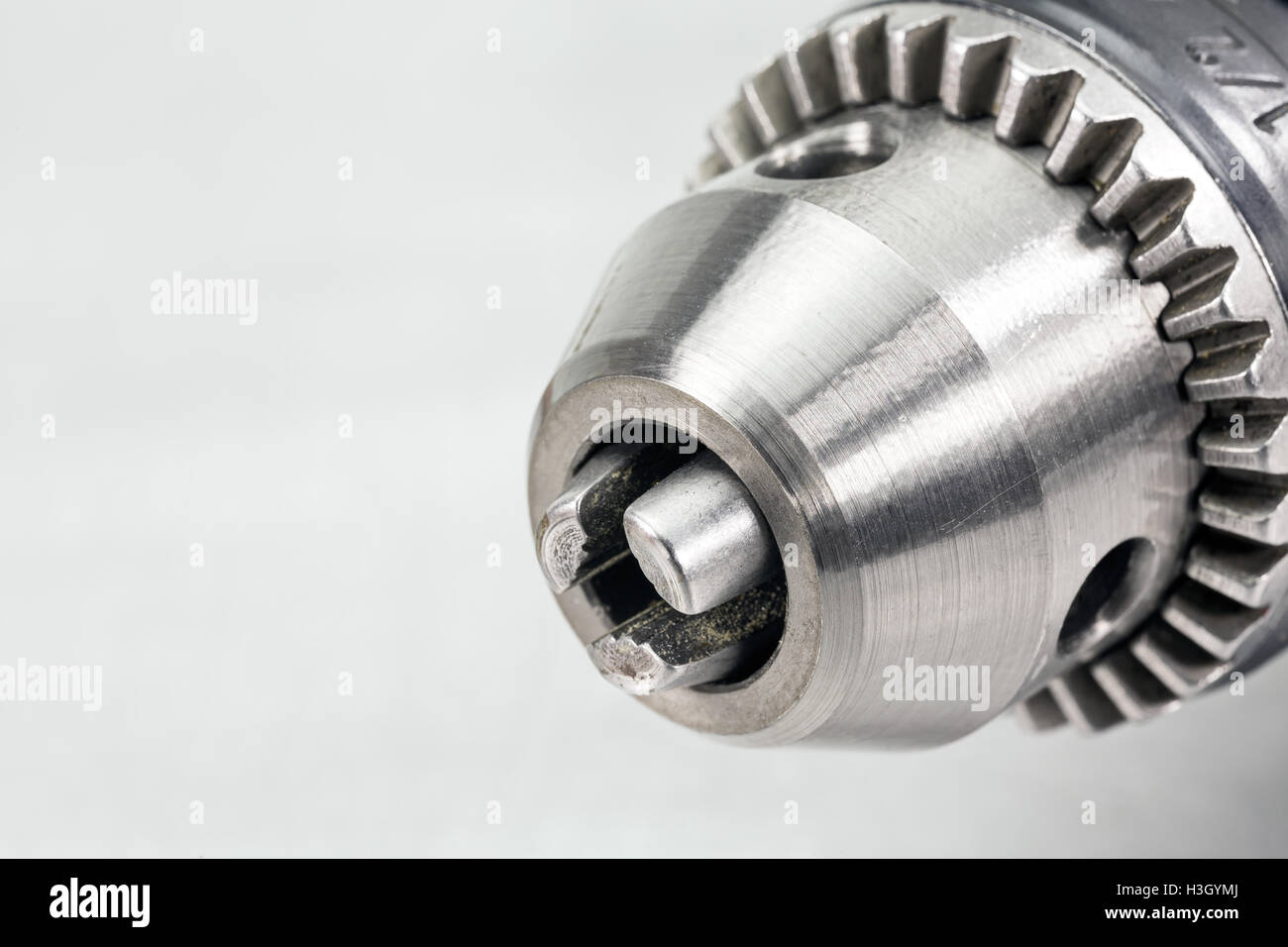 Closeup of power drill head on grey metal background Stock Photo - Alamy
