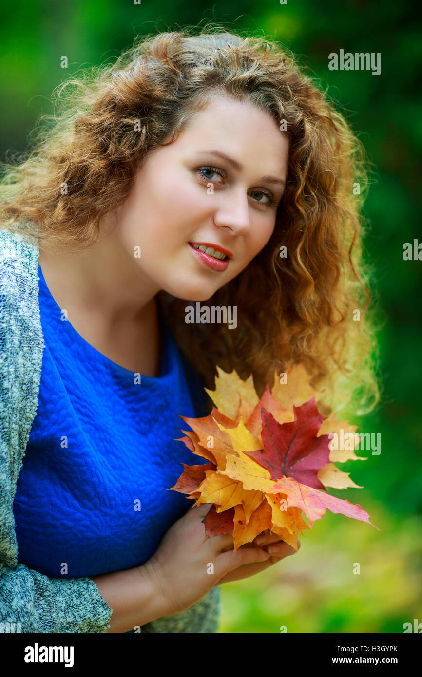 beautiful plus size model in the autumn park Stock Photo - Alamy
