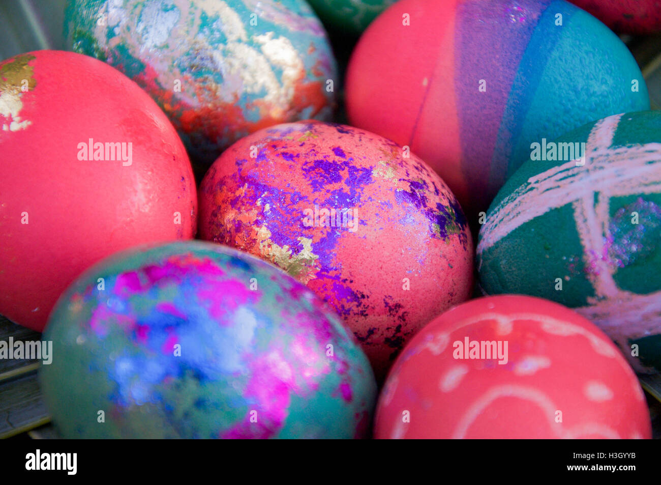 Closeup of colorfully dyed eggs with metallic accents in full frame ...