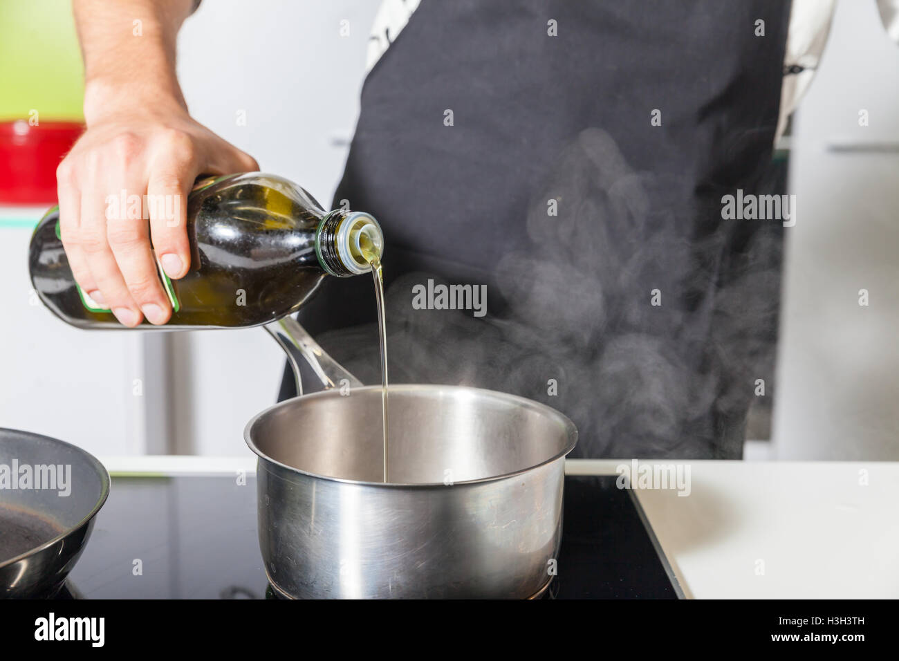 Man pouring oil Stock Photo - Alamy