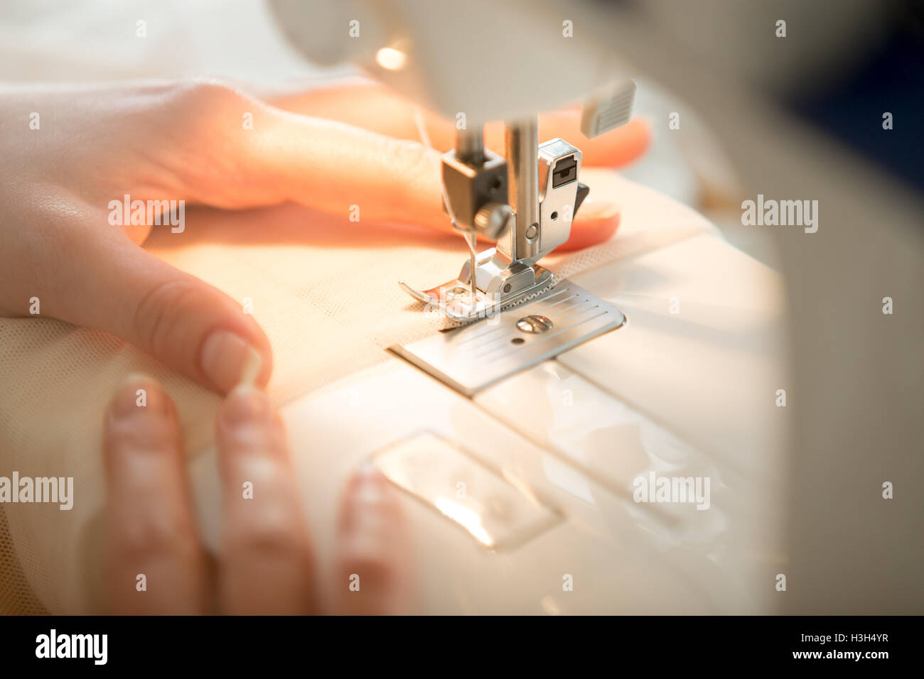 Hands at sewing machine Stock Photo - Alamy