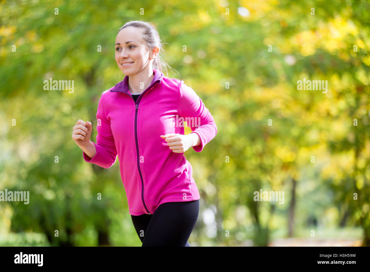 Portrait of an attractive woman jogging Stock Photo - Alamy