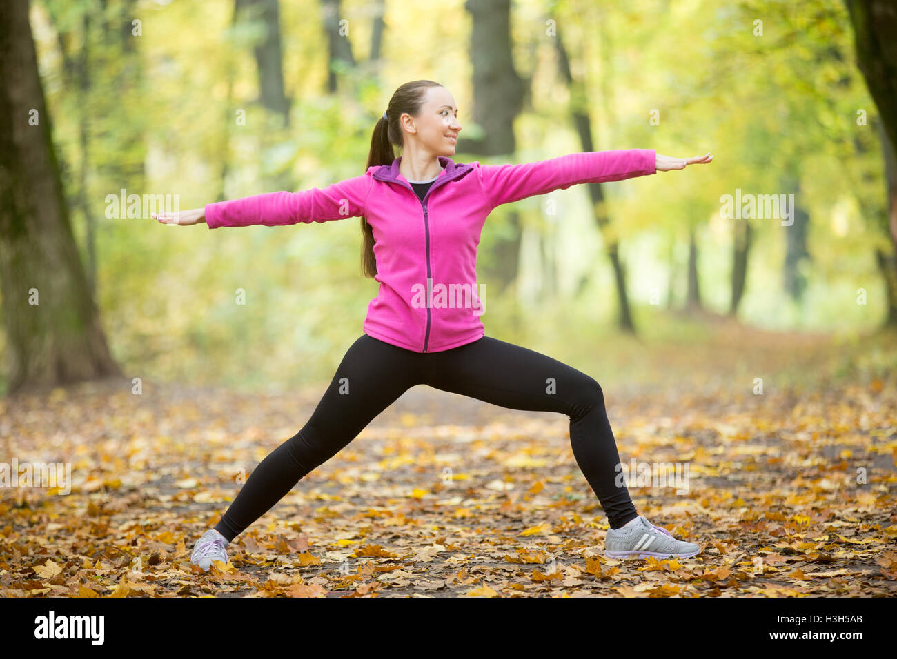 Yoga outdoors: Warrior Two pose Stock Photo - Alamy