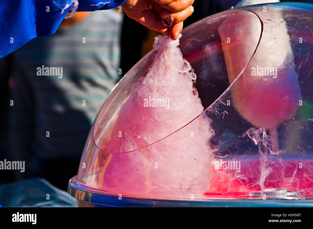 delicious cotton candy is hot prepared for children Stock Photo - Alamy