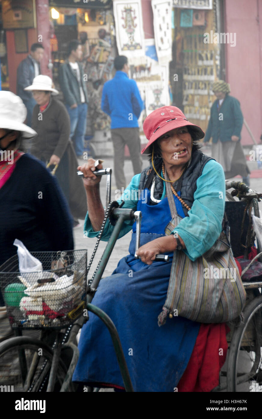 Aged Tibetan lady rides the streets of Lhasa on her tricycle Stock ...