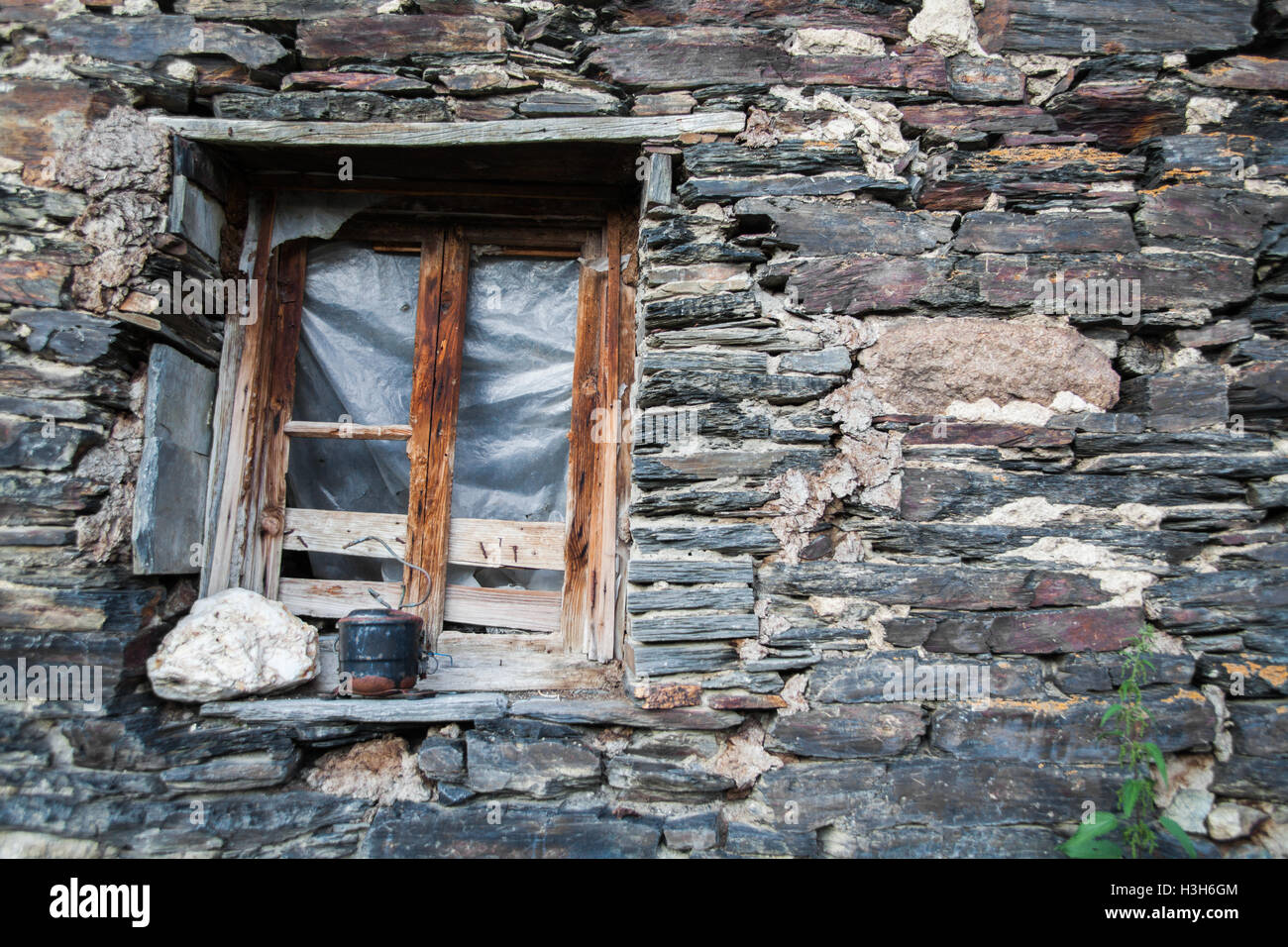 Color image of a broken window on a stone wall Stock Photo - Alamy