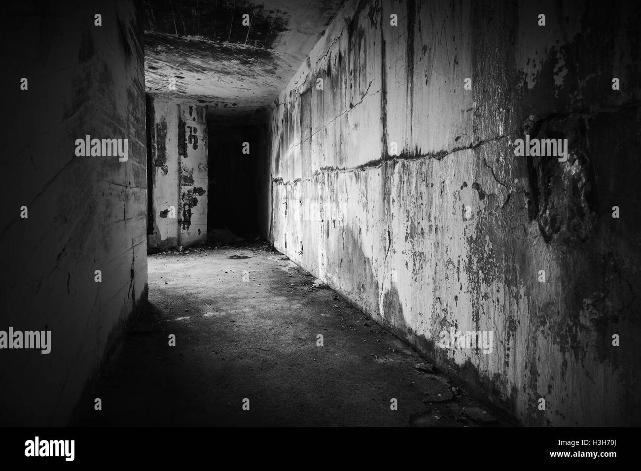 Empty abandoned bunker interior with dark end of grungy corridor, black ...