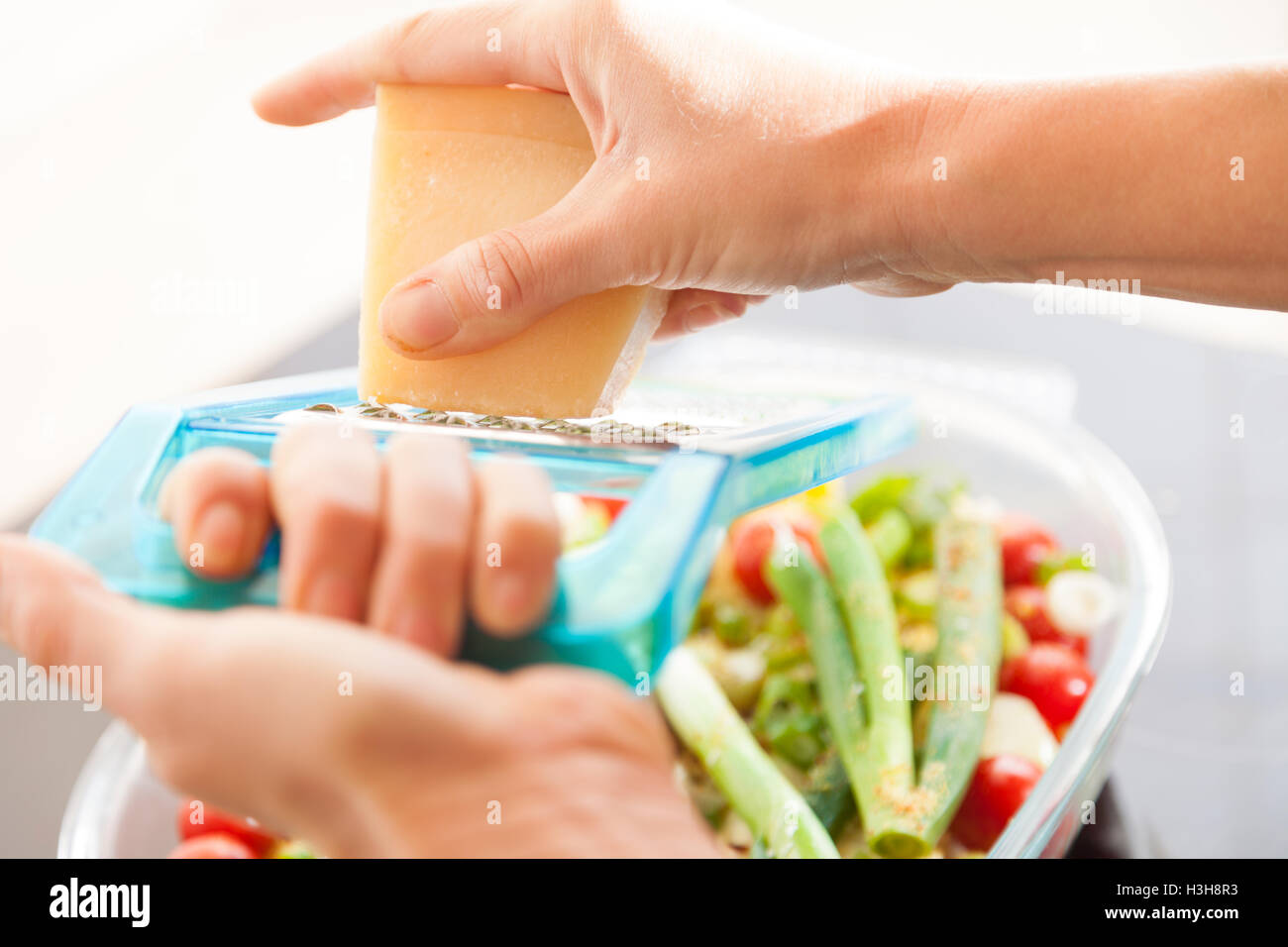 a hand on a cheese grater Stock Photo - Alamy