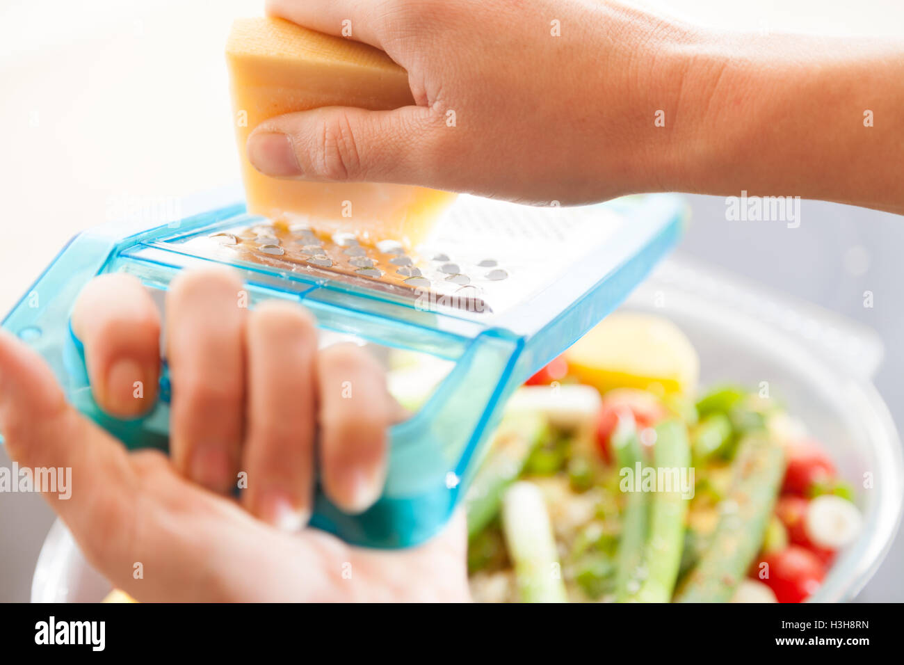a hand on a cheese grater Stock Photo - Alamy