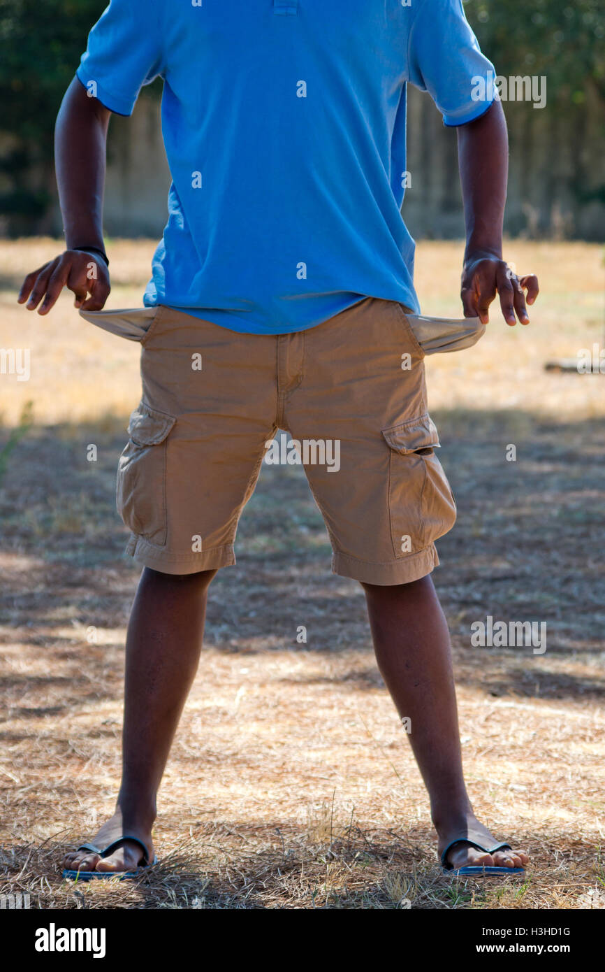 Poverty in the empty pockets of a young black man Stock Photo - Alamy