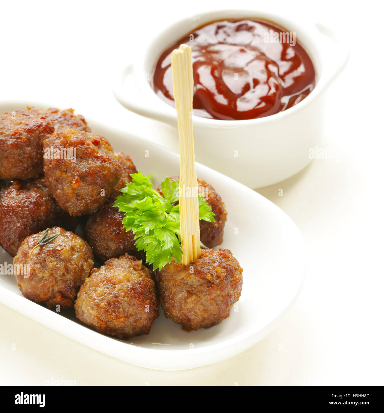 fried small meatballs with sauce on the plate Stock Photo - Alamy