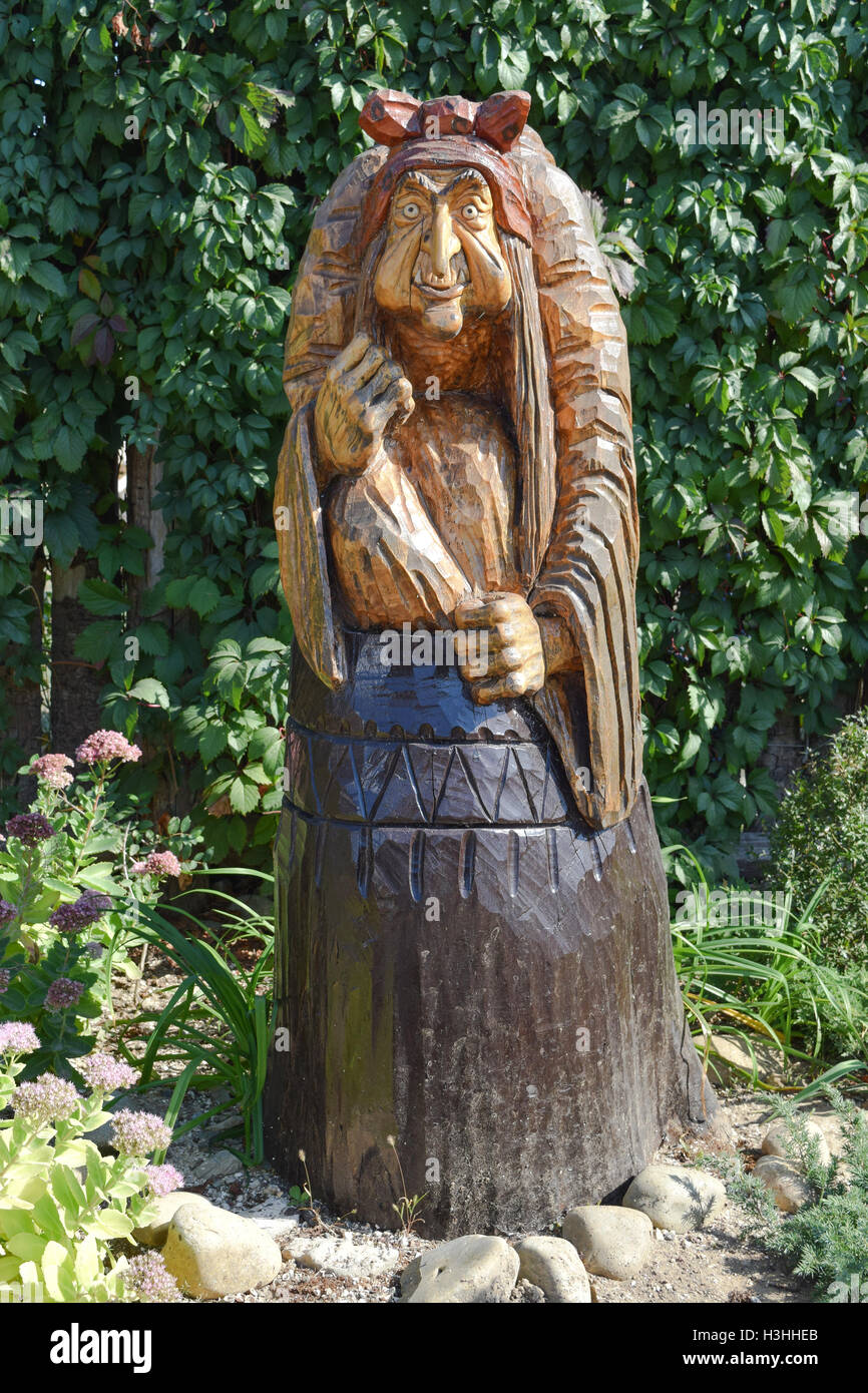 The wooden statue of Baba Yaga in a mortar. Fairy-tale characters Baba ...
