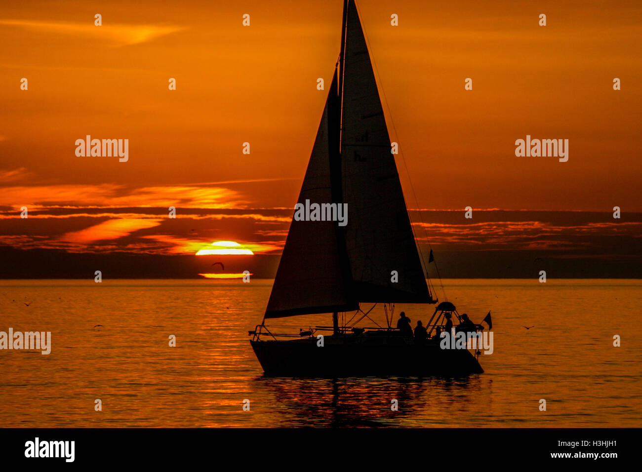 Casey Key, Florida with Saliboat at Red Sunset on the Gulf of Mexico ...
