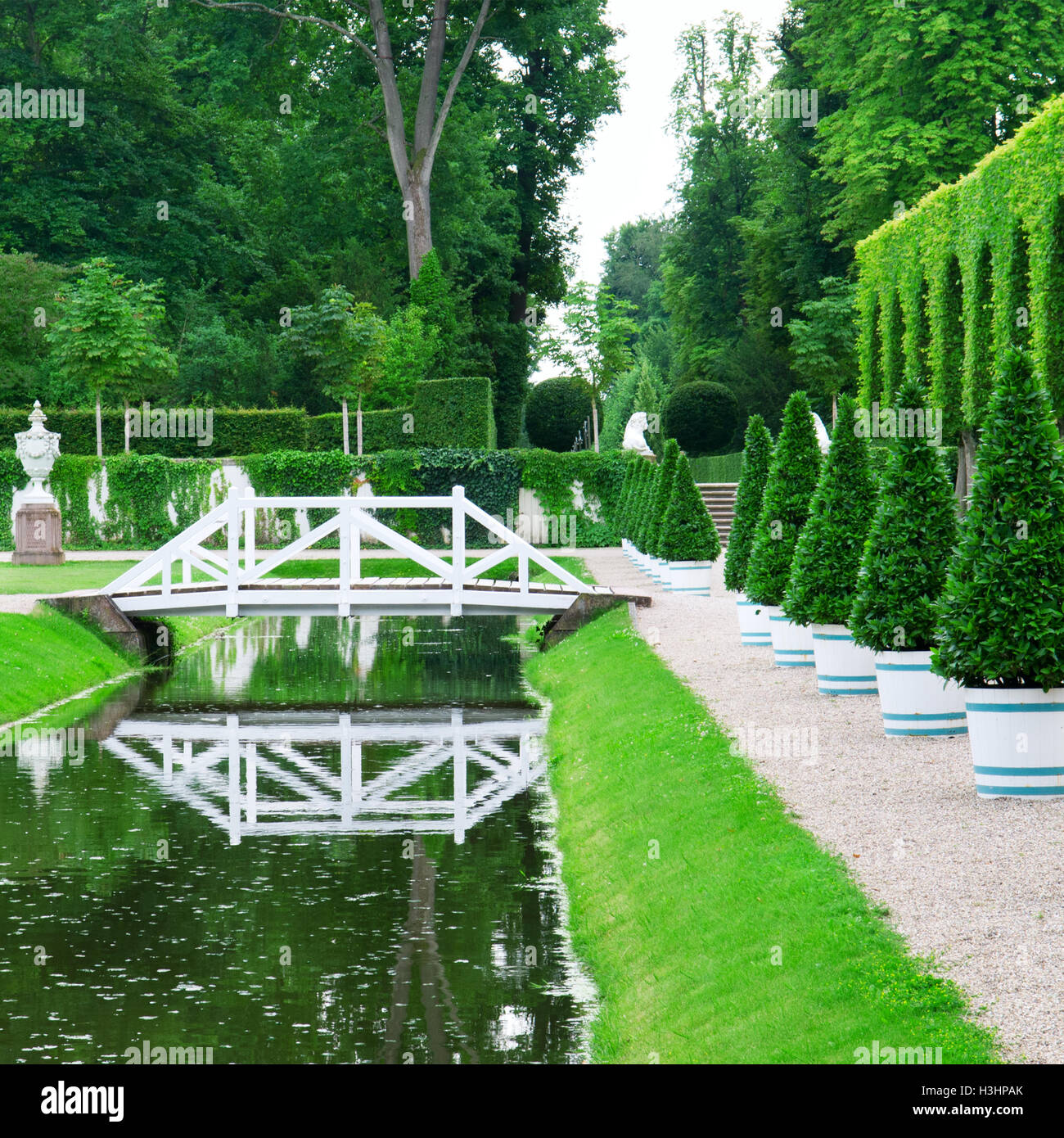 summer park with beautiful hedges, lake and bridge Stock Photo - Alamy