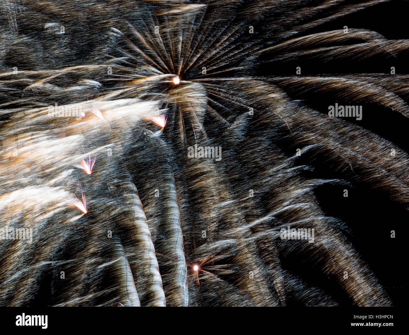 Wind blown gold and white. Spectacular fireworks Stock Photo - Alamy