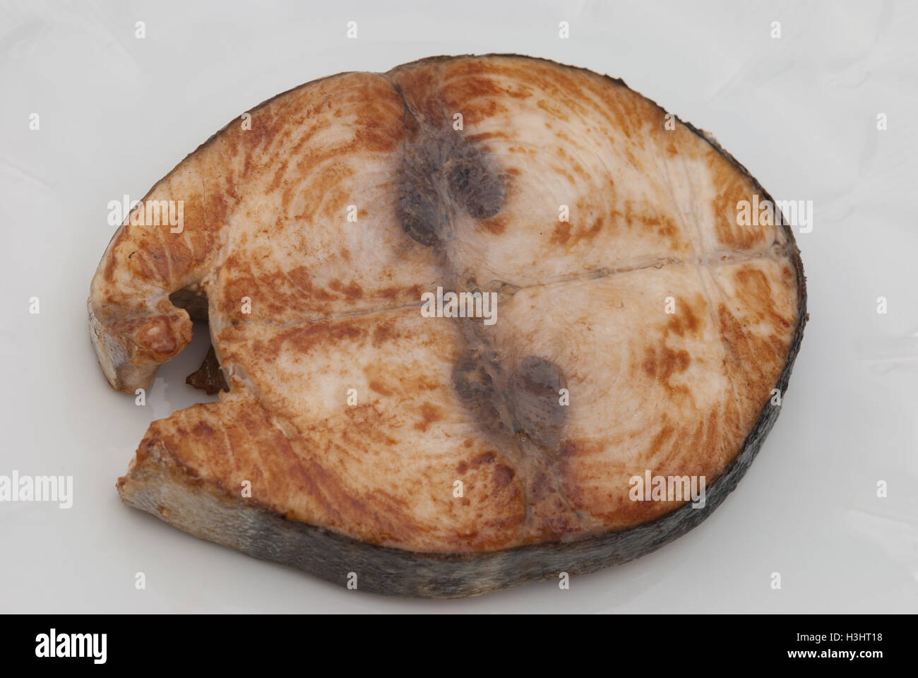 Fried tuna fish steak on the white plate closeup Stock Photo - Alamy