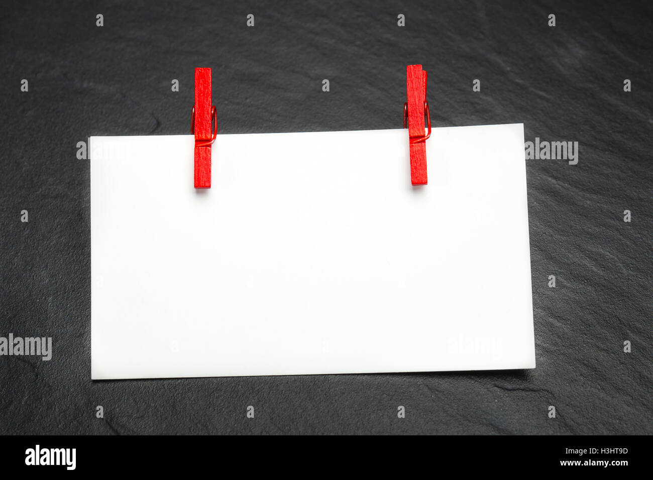 close up of a note paper and clothes pegs on a black background Stock ...