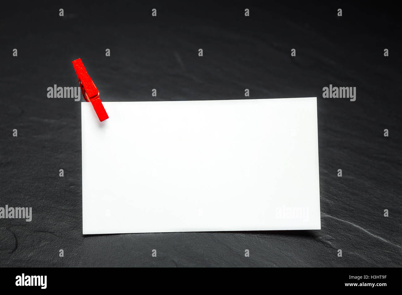 close up of a note paper and clothes pegs on a black background Stock ...