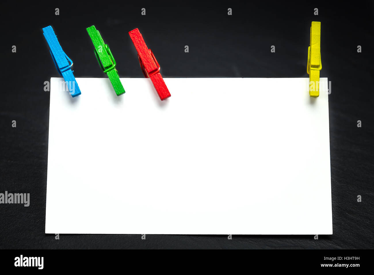 close up of a note paper and clothes pegs on a black background Stock ...