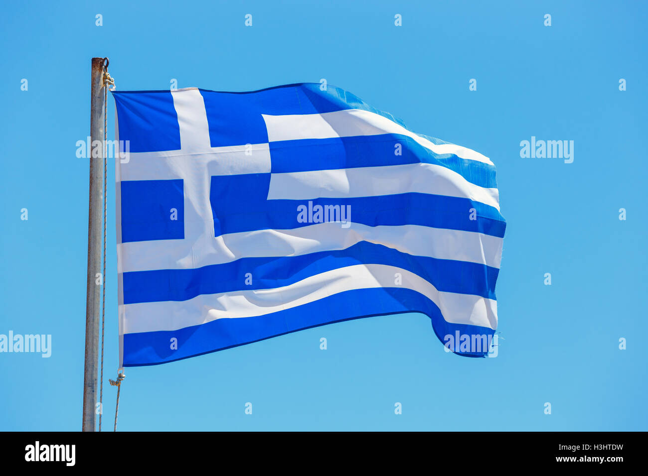 Greek flag on the blue sky background Stock Photo - Alamy