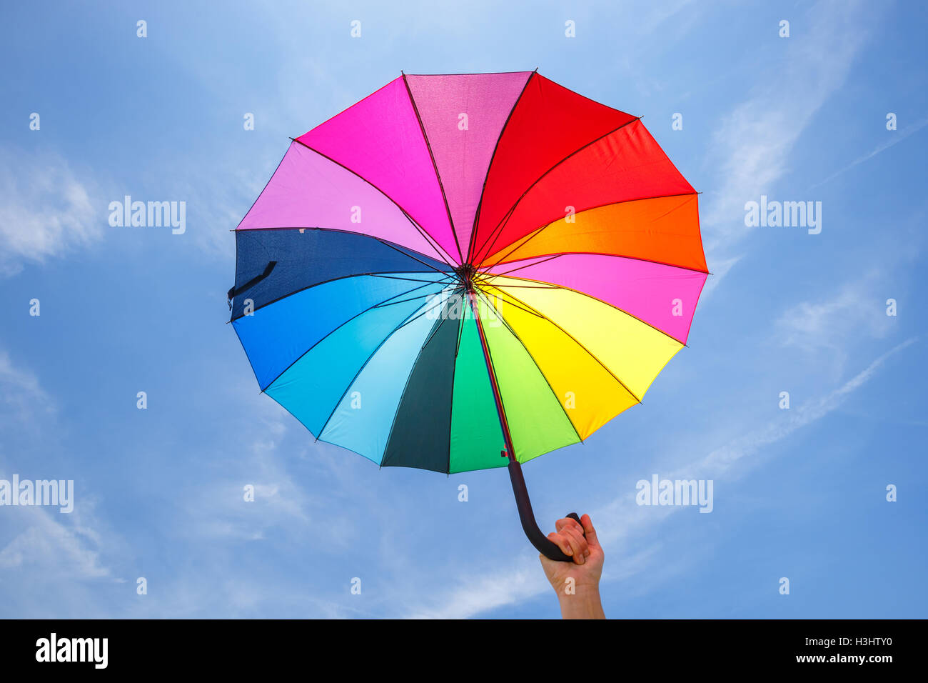 open colorful rainbow umbrella on blue sky background Stock Photo - Alamy