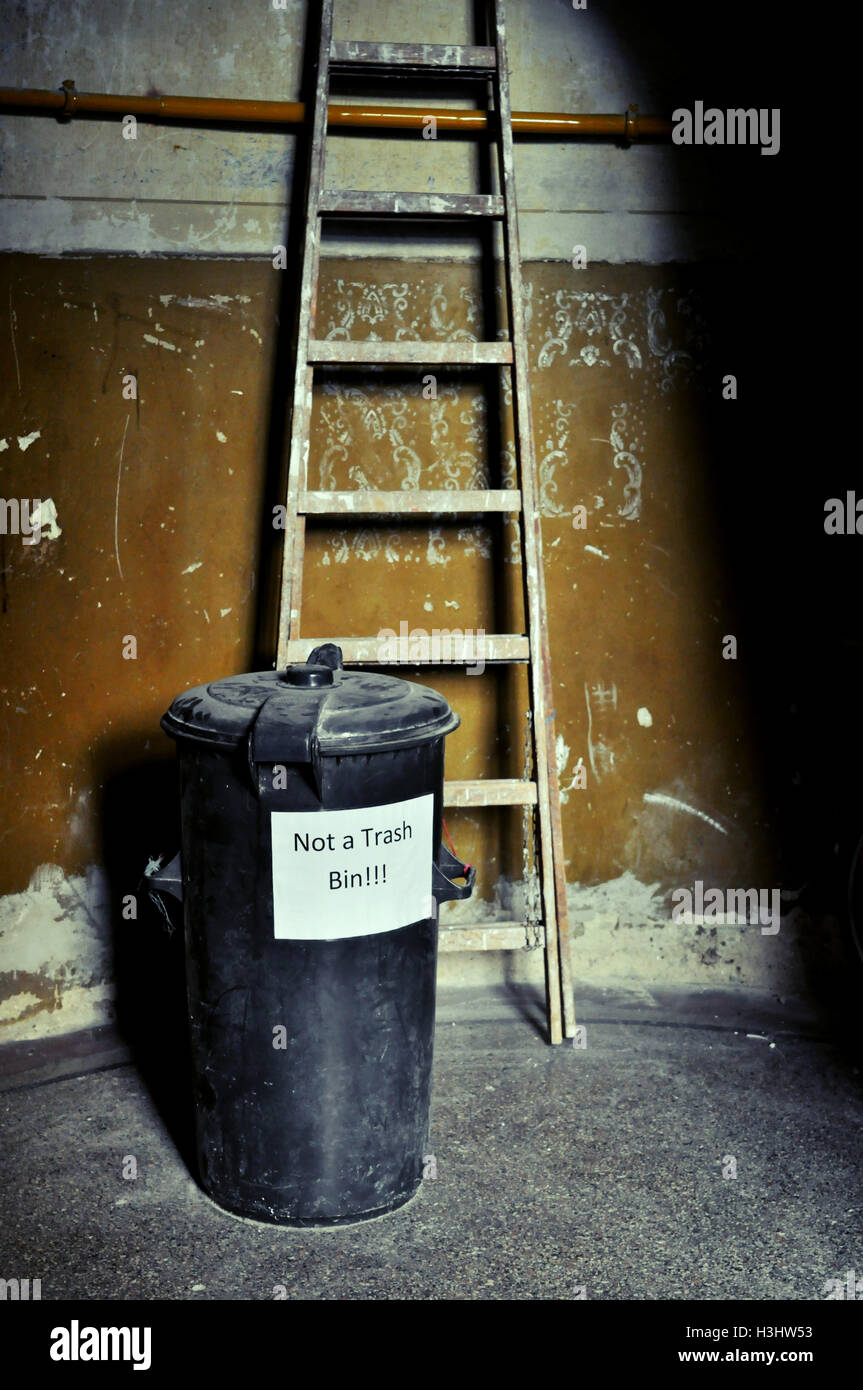 Bin by the ladder with a sign "Not a trash bin Stock Photo - Alamy