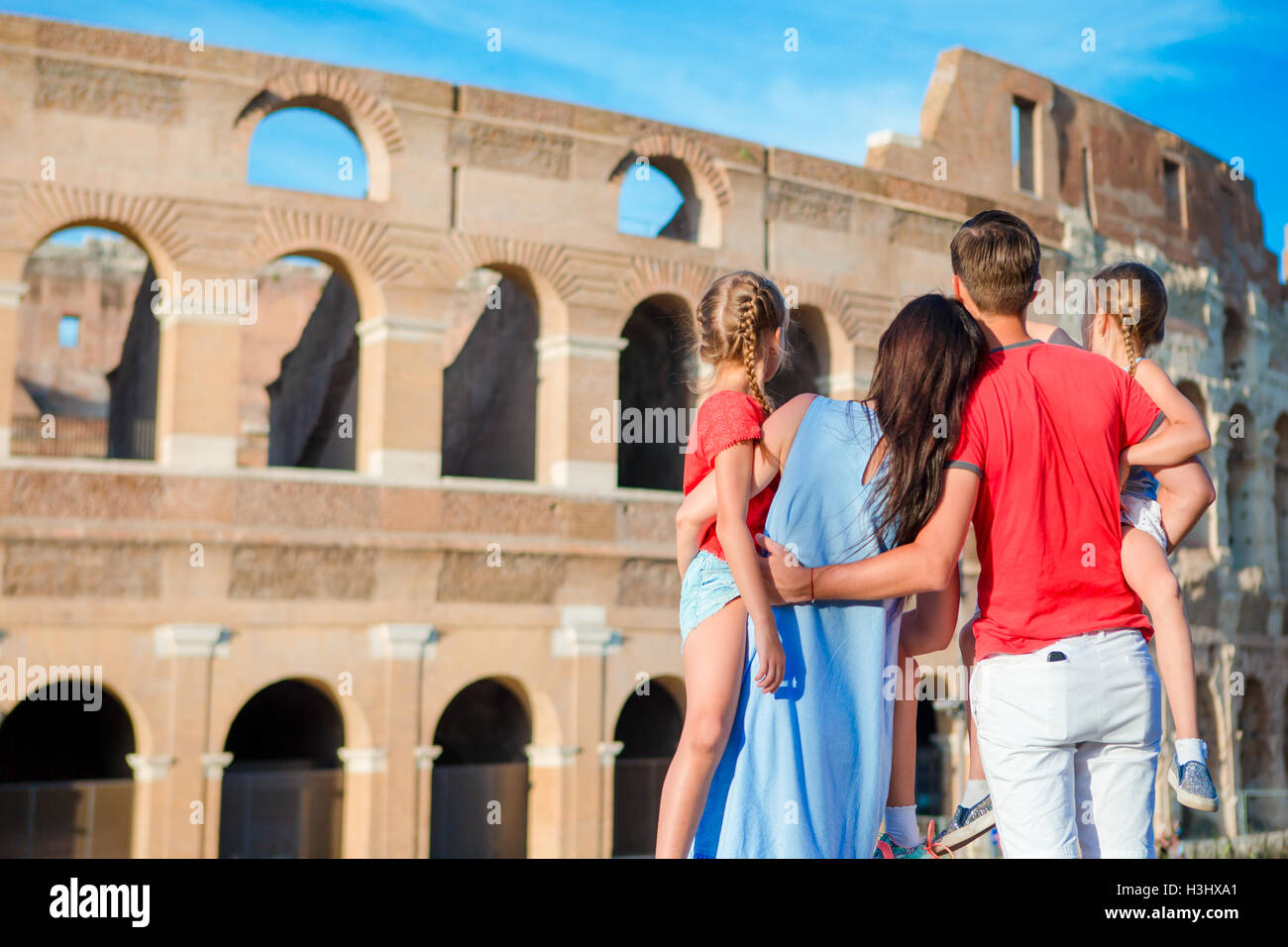 Happy family in Europe. Parents and kids in Rome over Coliseum ...