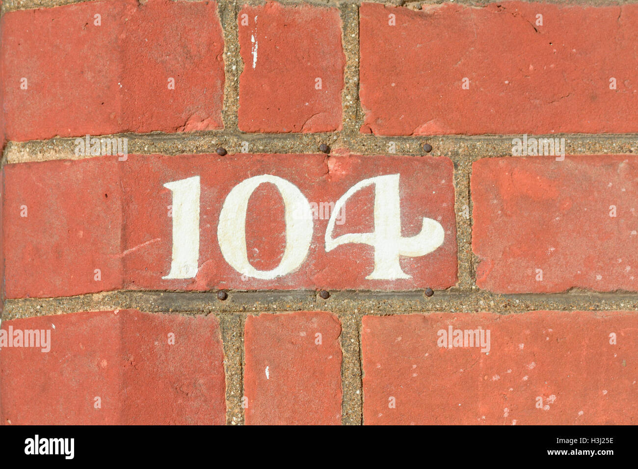 House number 104 sign painted on wall Stock Photo - Alamy