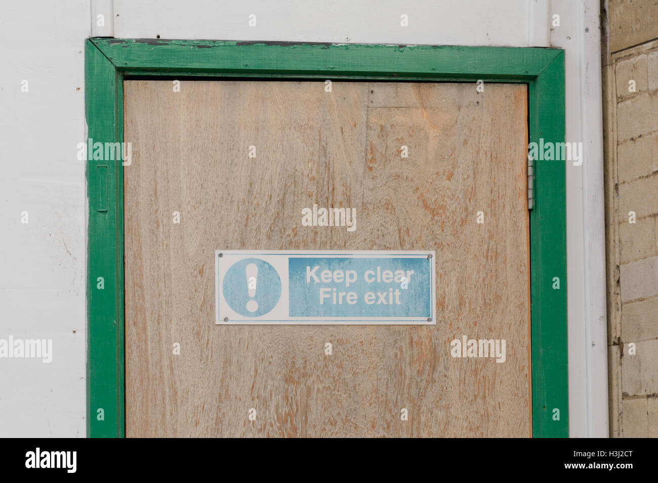 Faded Fire Exit Keep Clear sign on door Stock Photo - Alamy