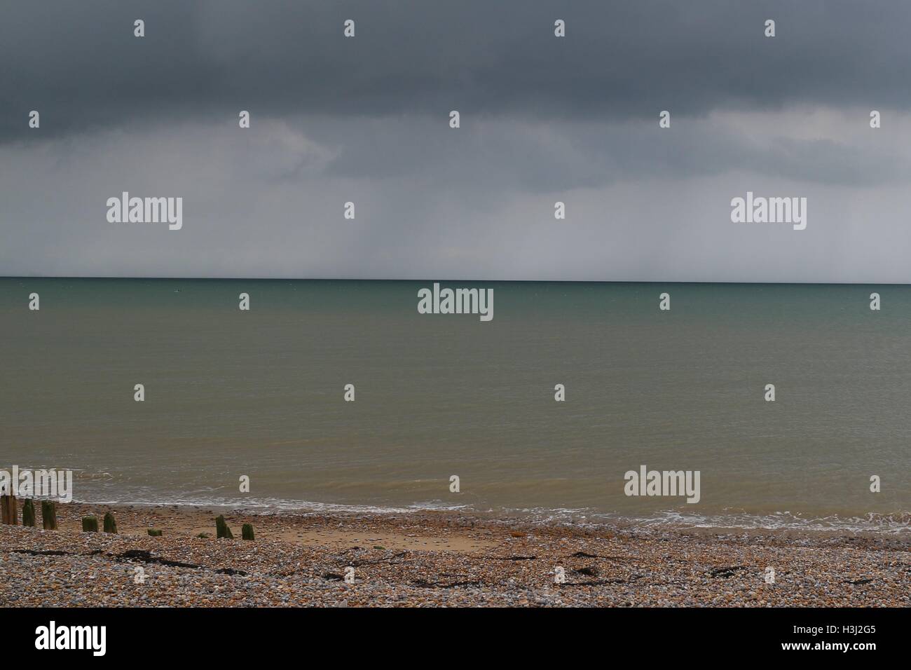 Dark clouds over beach hi-res stock photography and images - Alamy